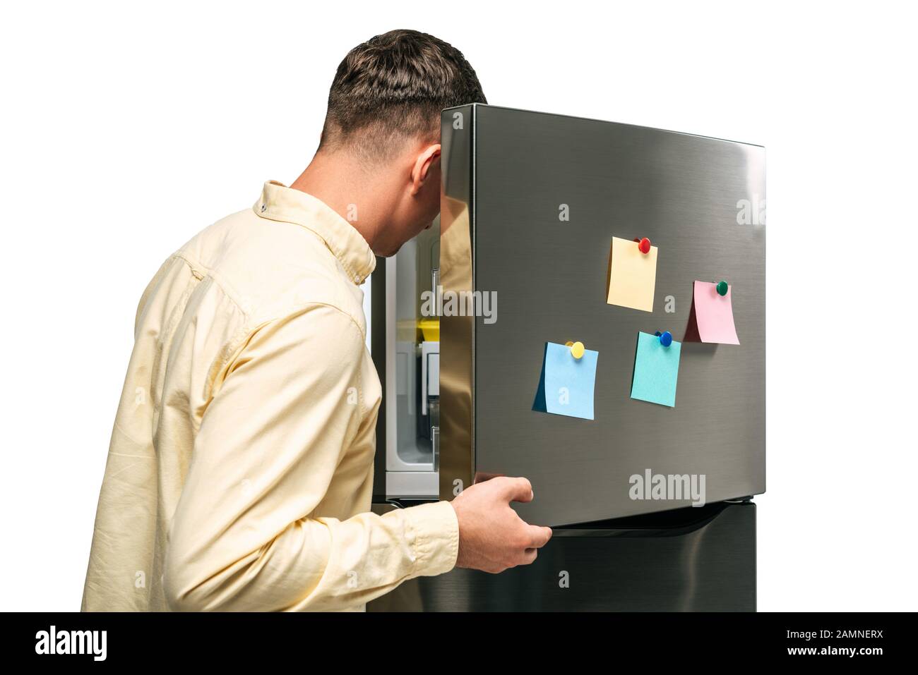 guy looking in open fridge with sticky notes isolated on white Stock ...
