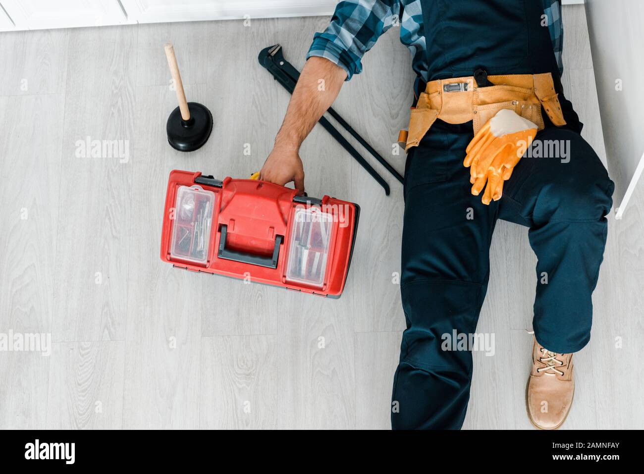 top view of repair lying on floor and working near toolbox Stock Photo ...