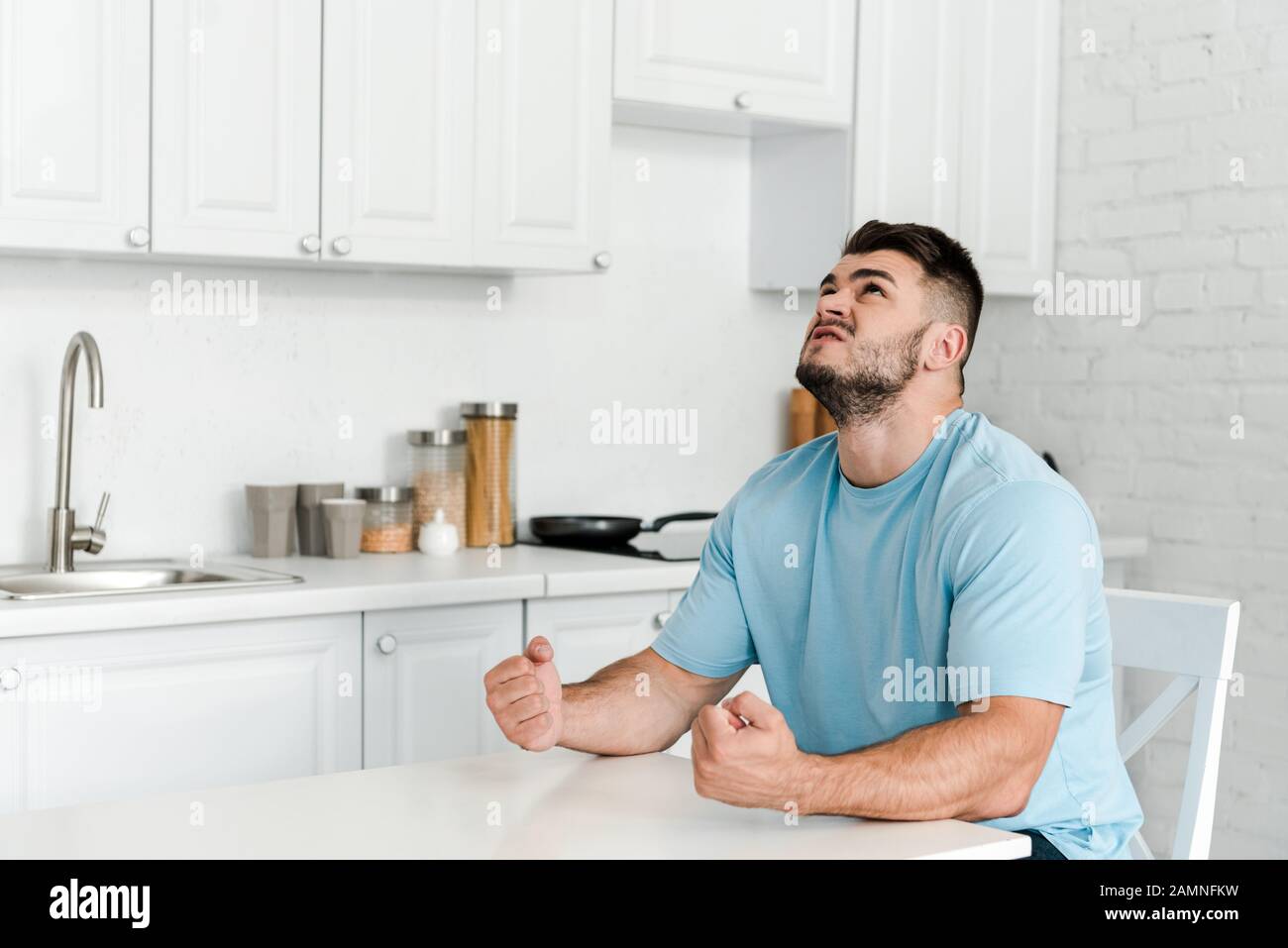 Angry man sitting table in hi-res stock photography and images - Alamy