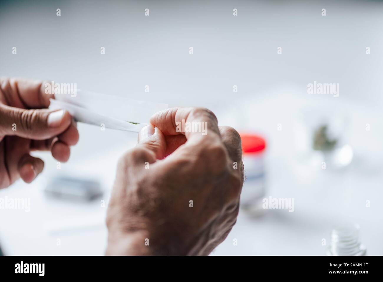 cropped view of man rolling blunt with medical cannabis Stock Photo - Alamy