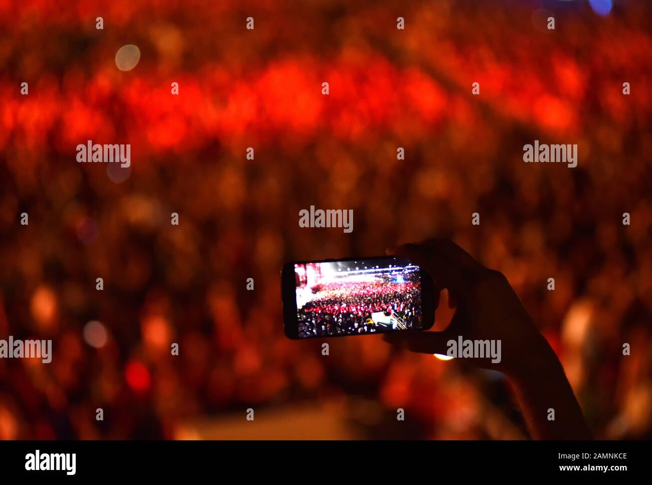 Hand holding smart phone and recording concert at music festival Stock ...