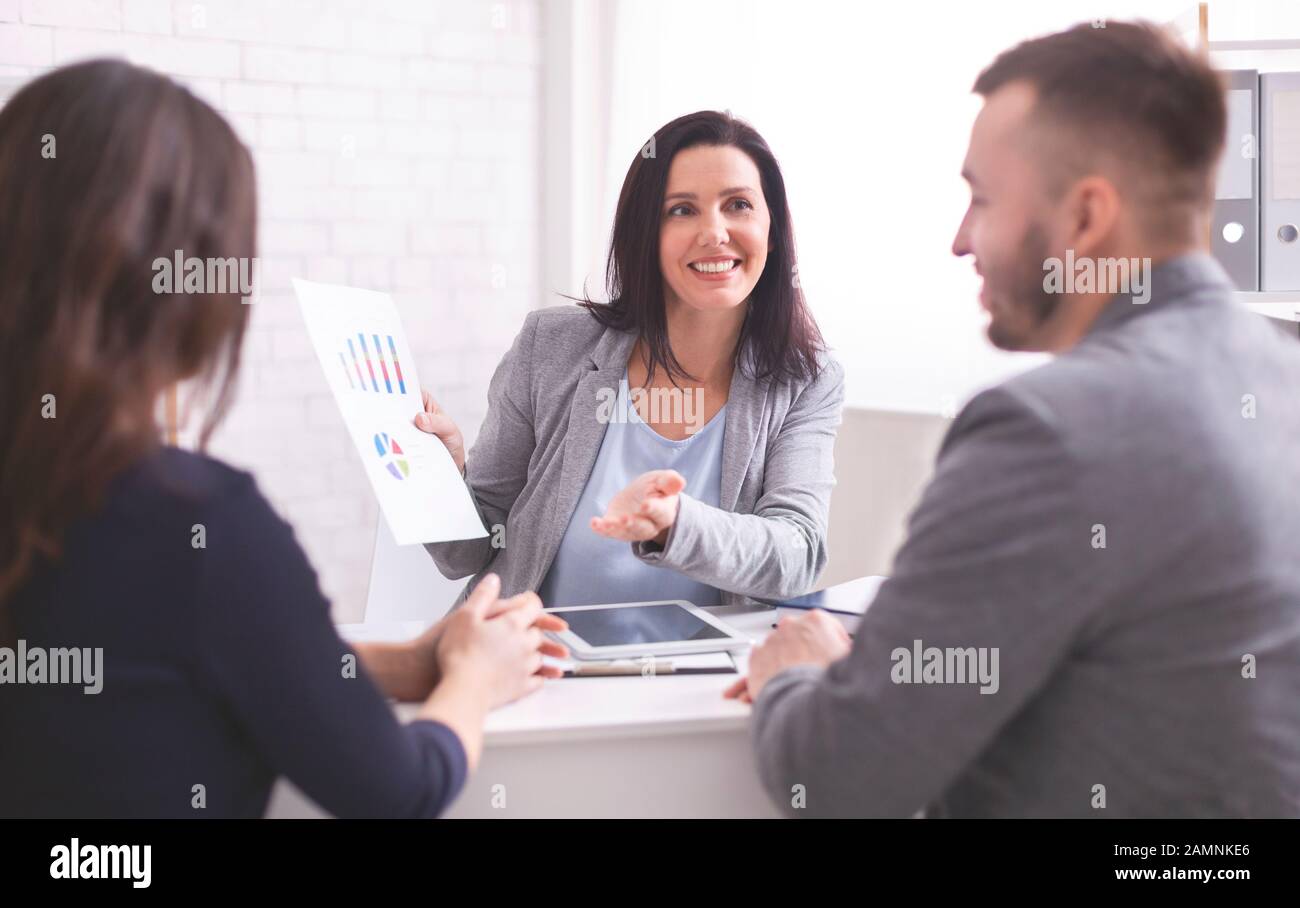 Cheerful expert explaining investment plan to new clients Stock Photo ...