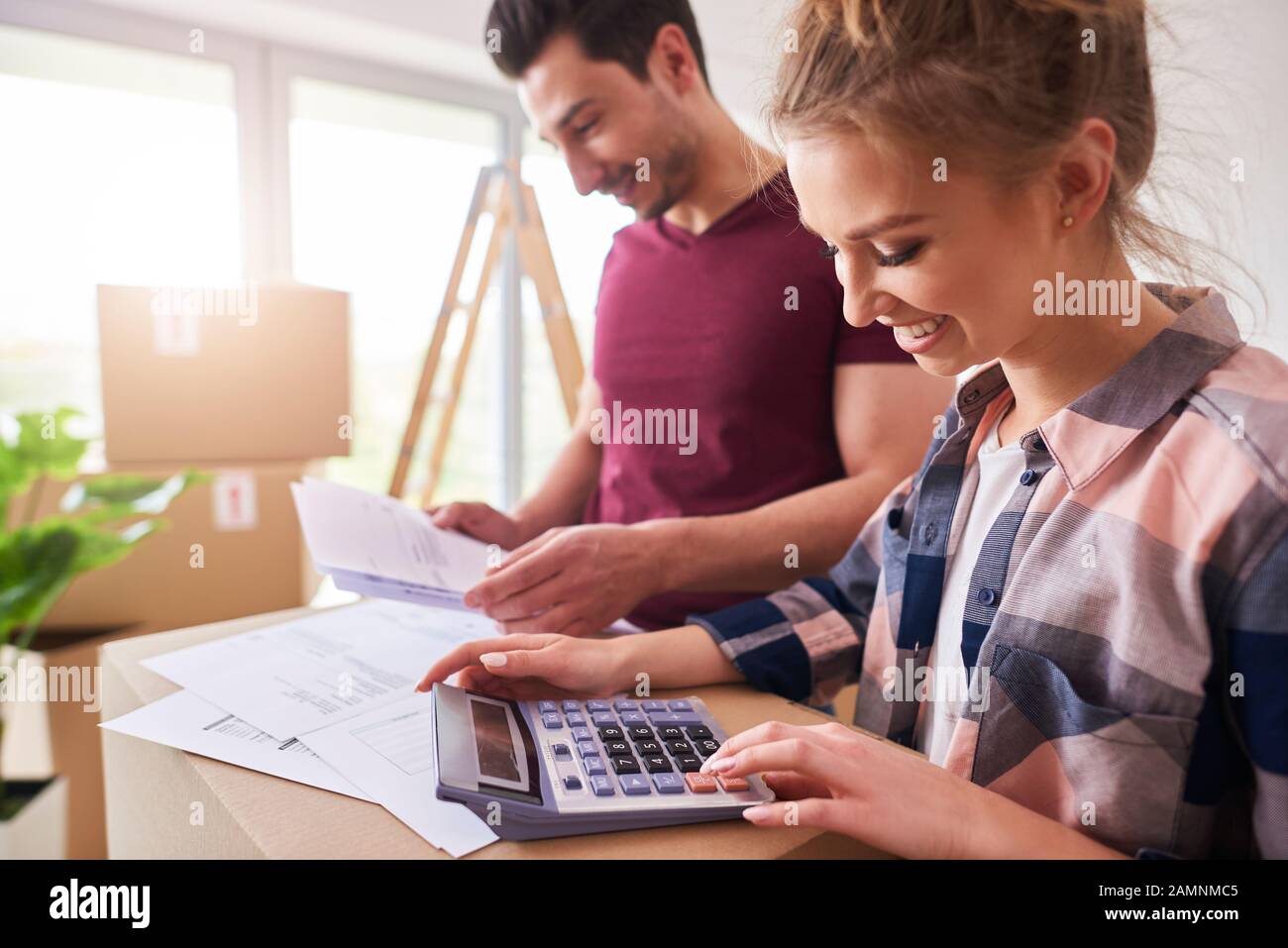 Happy couple planning their budget Stock Photo - Alamy