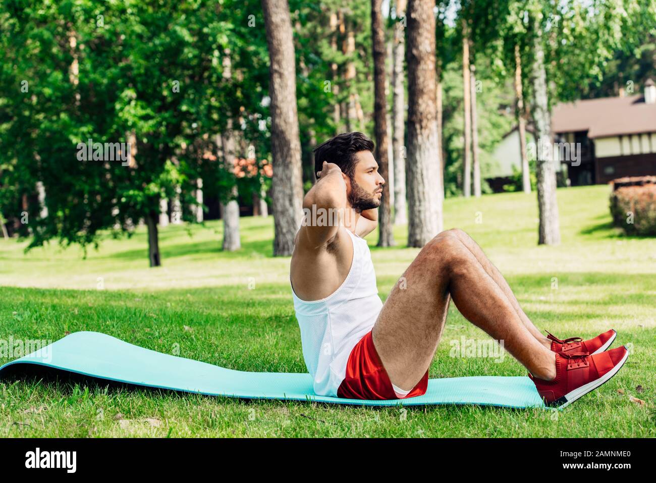 side view of bearded sportsman doing do abs on fitness mat Stock Photo ...