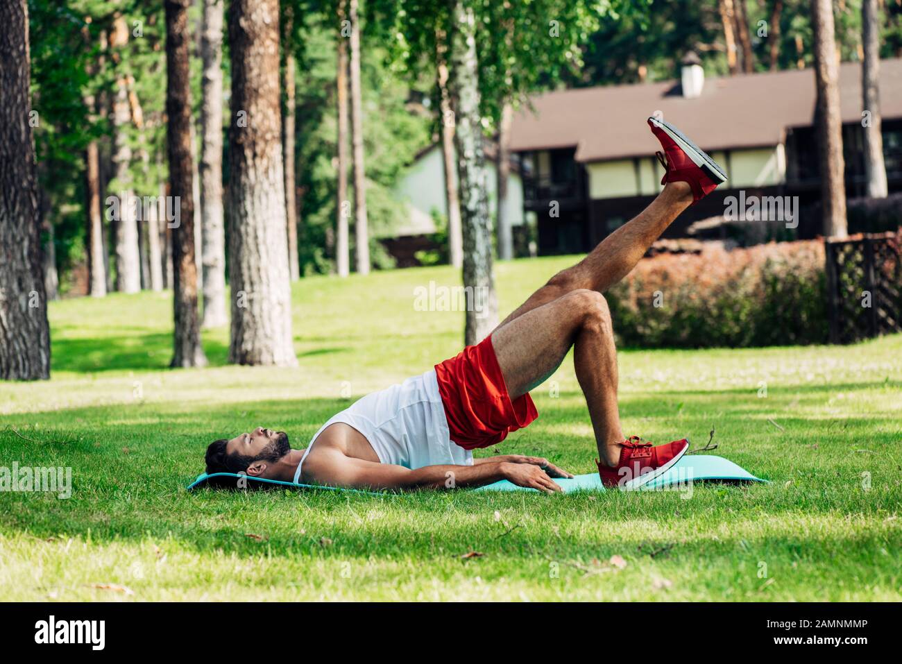 athletic sportsman working out on fitness mat outside Stock Photo - Alamy