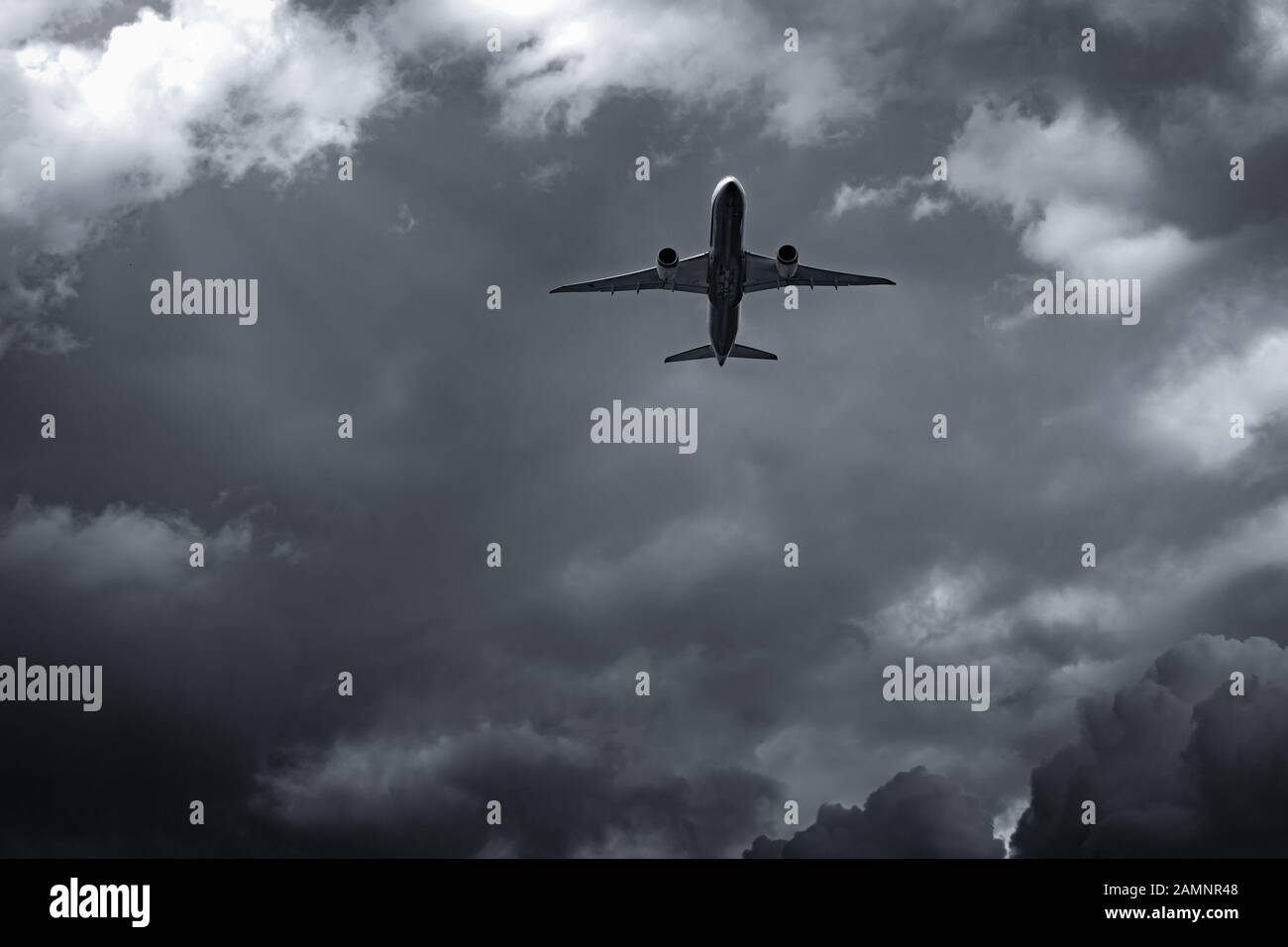 Airplane flying on dark sky and white clouds. Commercial airline with ...