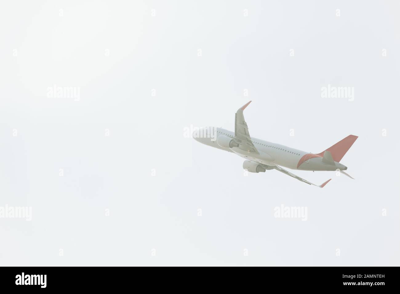 Low angle view of commercial plane taking off in cloudy sky Stock Photo ...