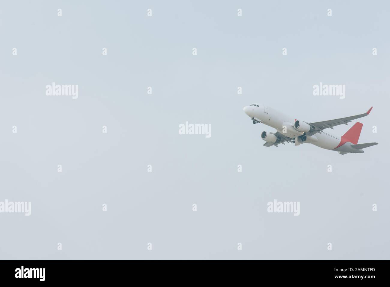 Low angle view of plane landing in cloudy sky Stock Photo - Alamy