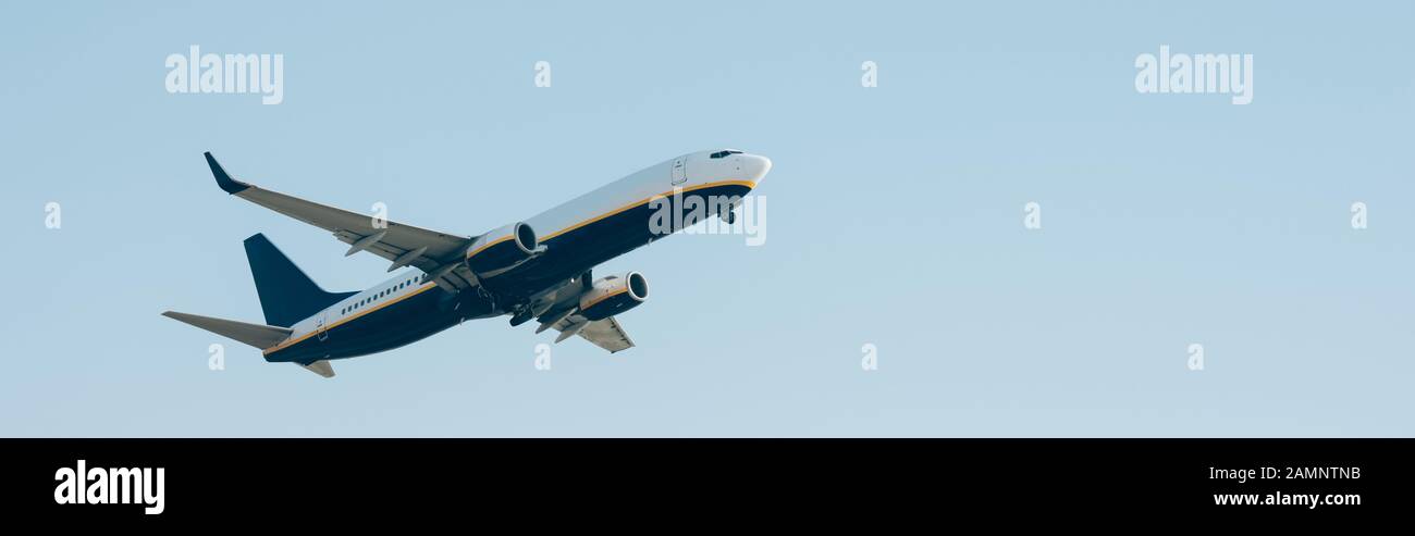 Commercial jet plane taking off in blue sky, panoramic shot Stock Photo ...