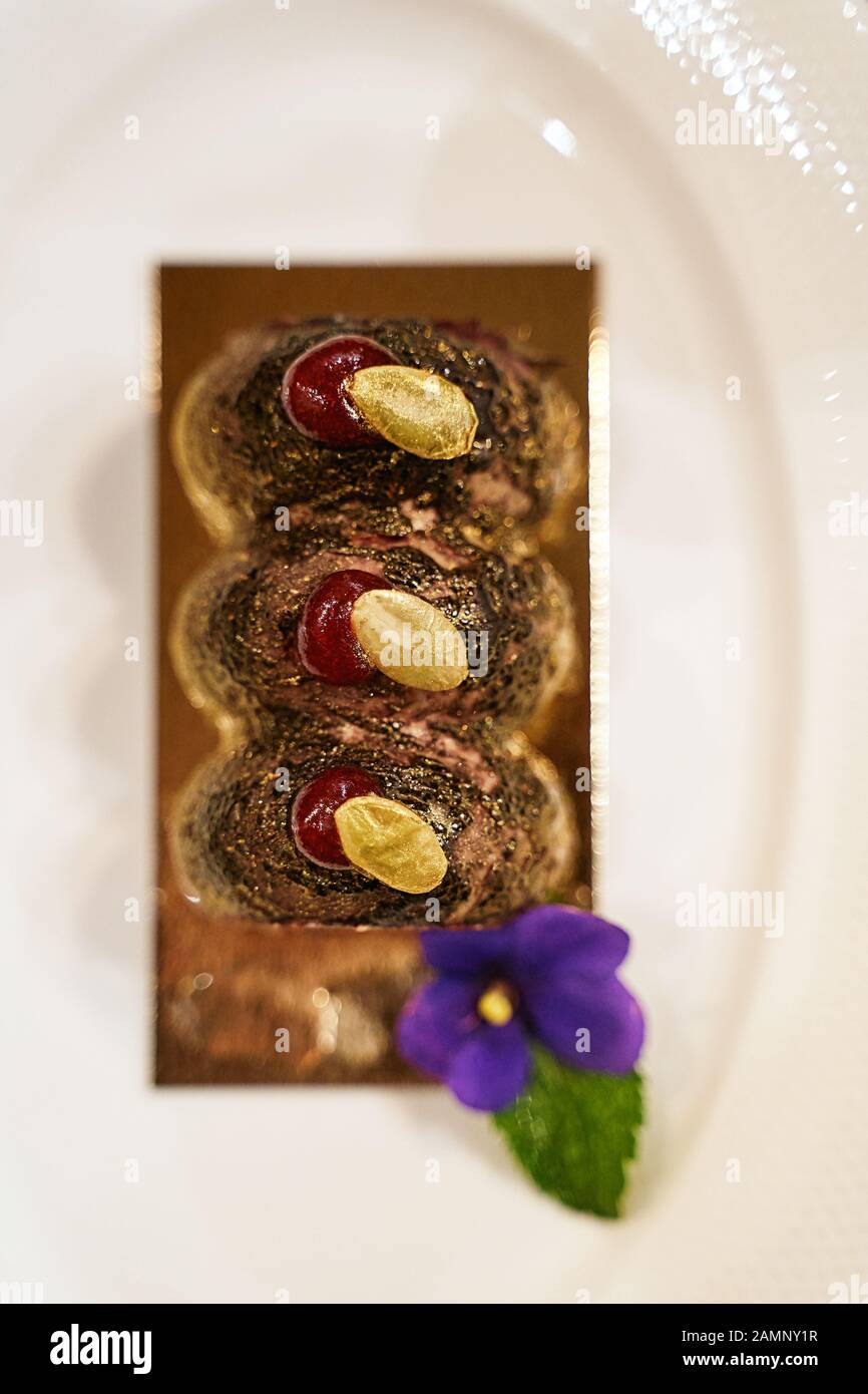 Haute cuisine or high kitchen food concept. Chocolate coated duck liver ...