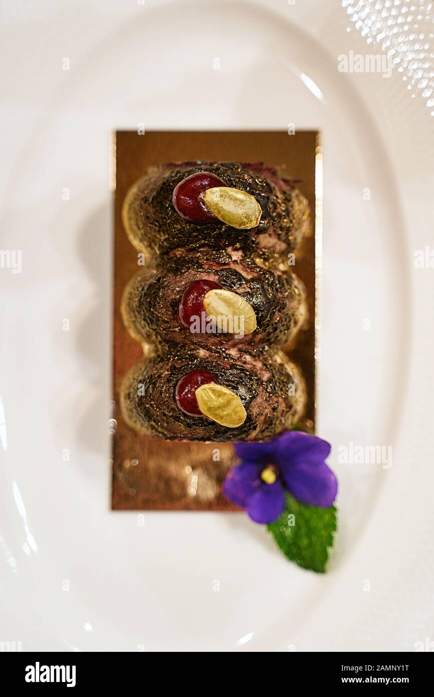 Haute cuisine or high kitchen food concept. Chocolate coated duck liver ...