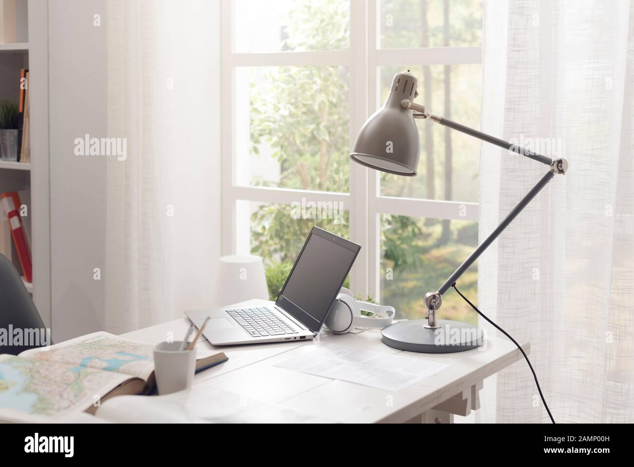 Modern student room with desk and laptop, window in the background ...