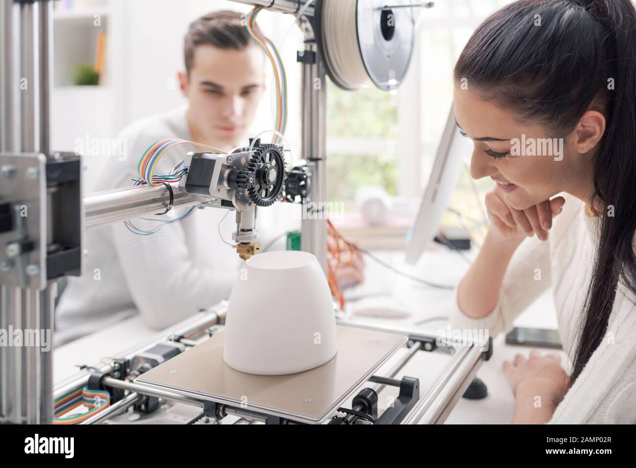 Engineering students using an innovative 3D printer in the university ...