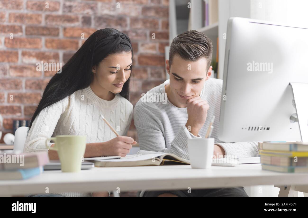 Young academic students at the library, they are studying together and ...