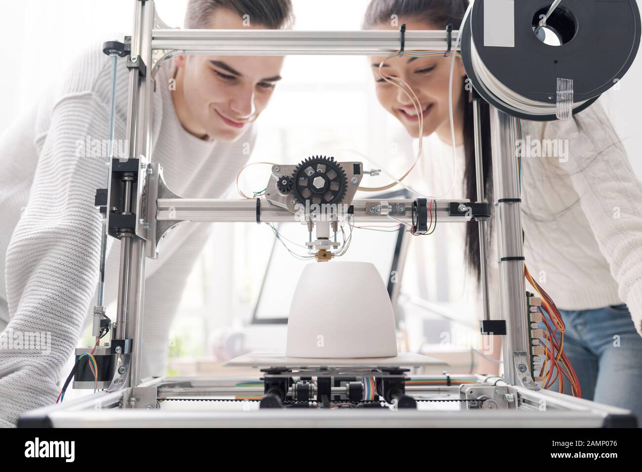 Engineering students using an innovative 3D printer in the university ...