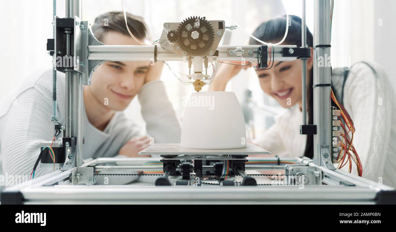 Engineering students using an innovative 3D printer in the university ...