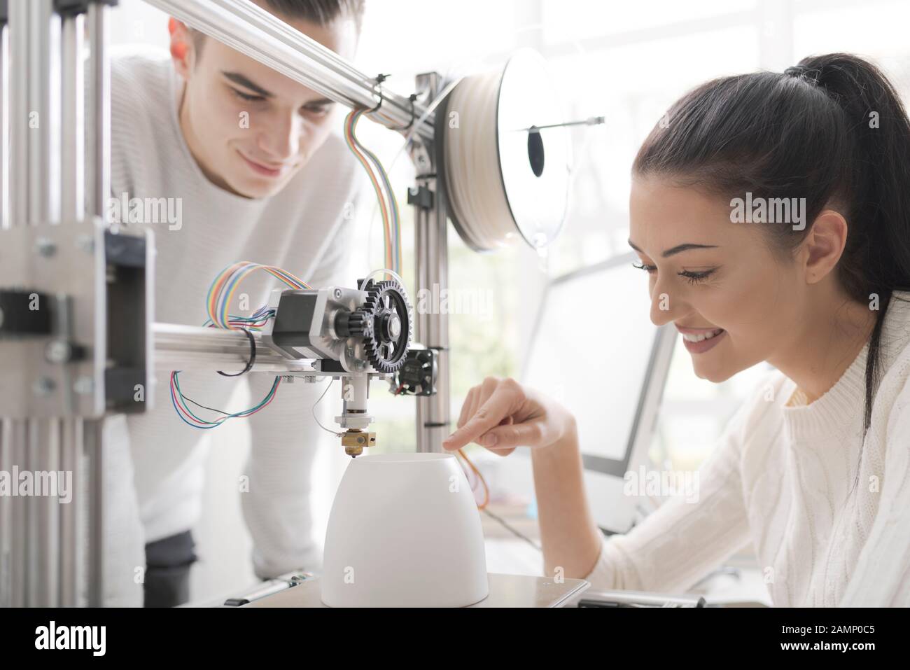 Engineering students using an innovative 3D printer in the university ...
