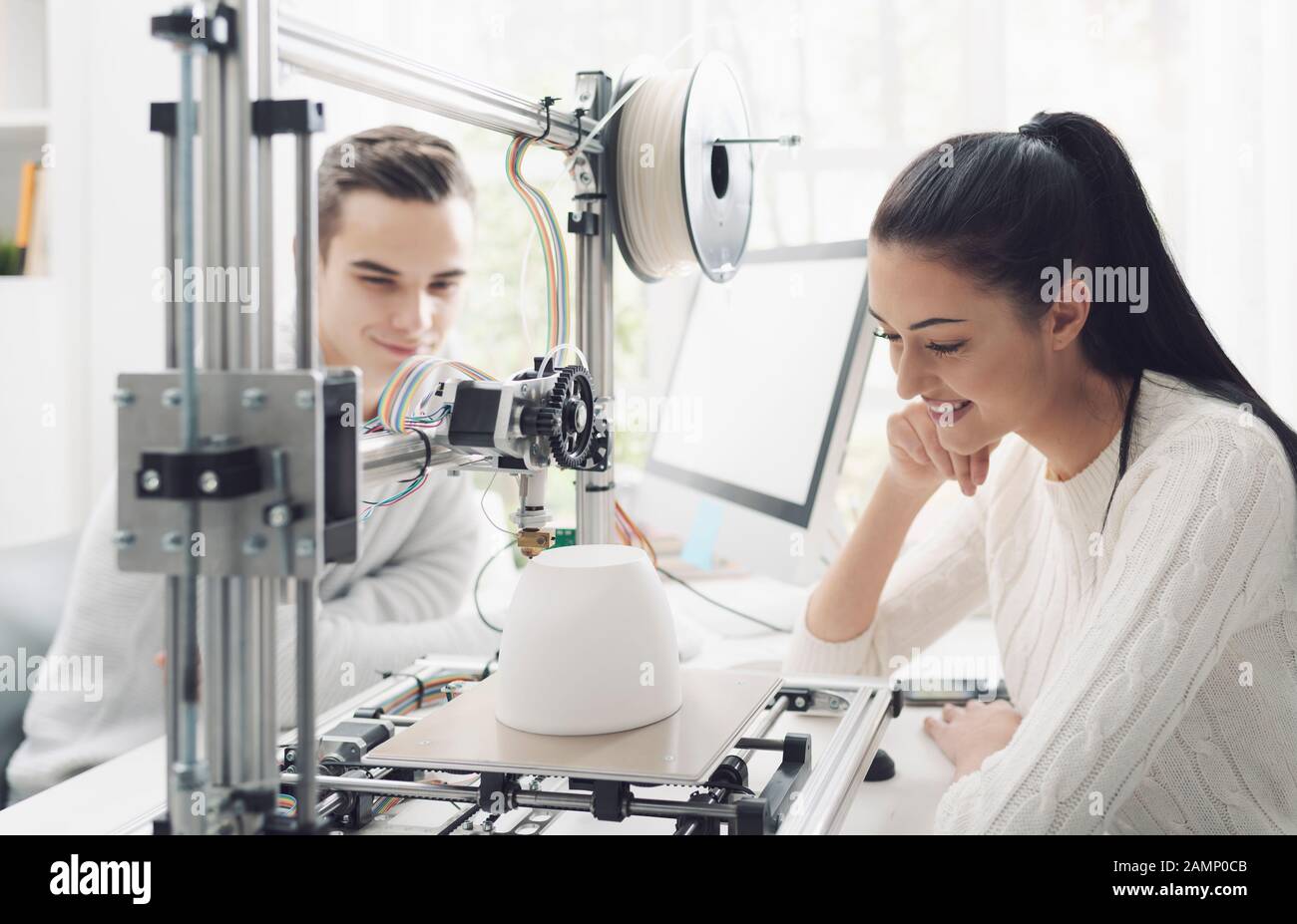 Engineering students using an innovative 3D printer in the university ...
