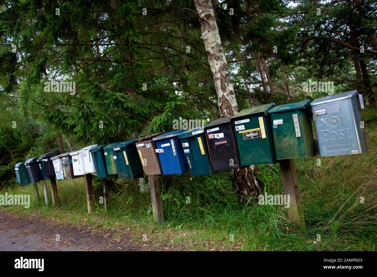 Row of colorful mailboxes standing outdoor by the road in summer in ...