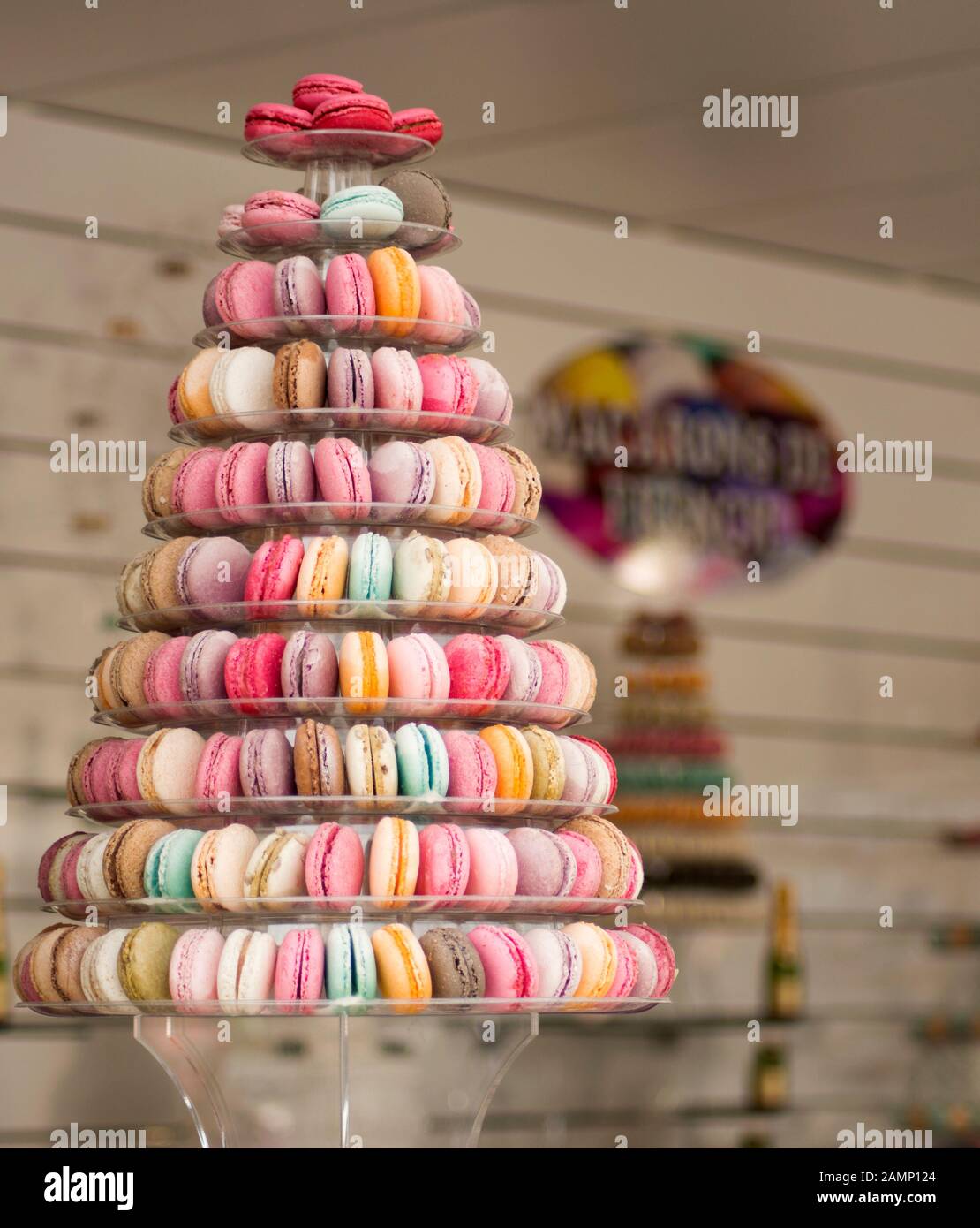 Pyramid of multi-colored macarons on pastel blue background. Delicious ...
