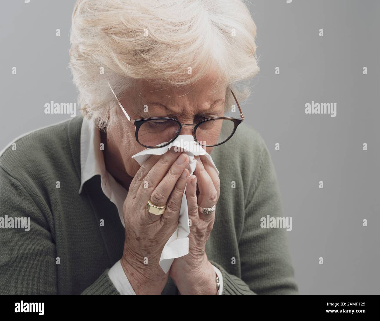 Sick senior lady blowing her nose, she has cold and flu Stock Photo - Alamy