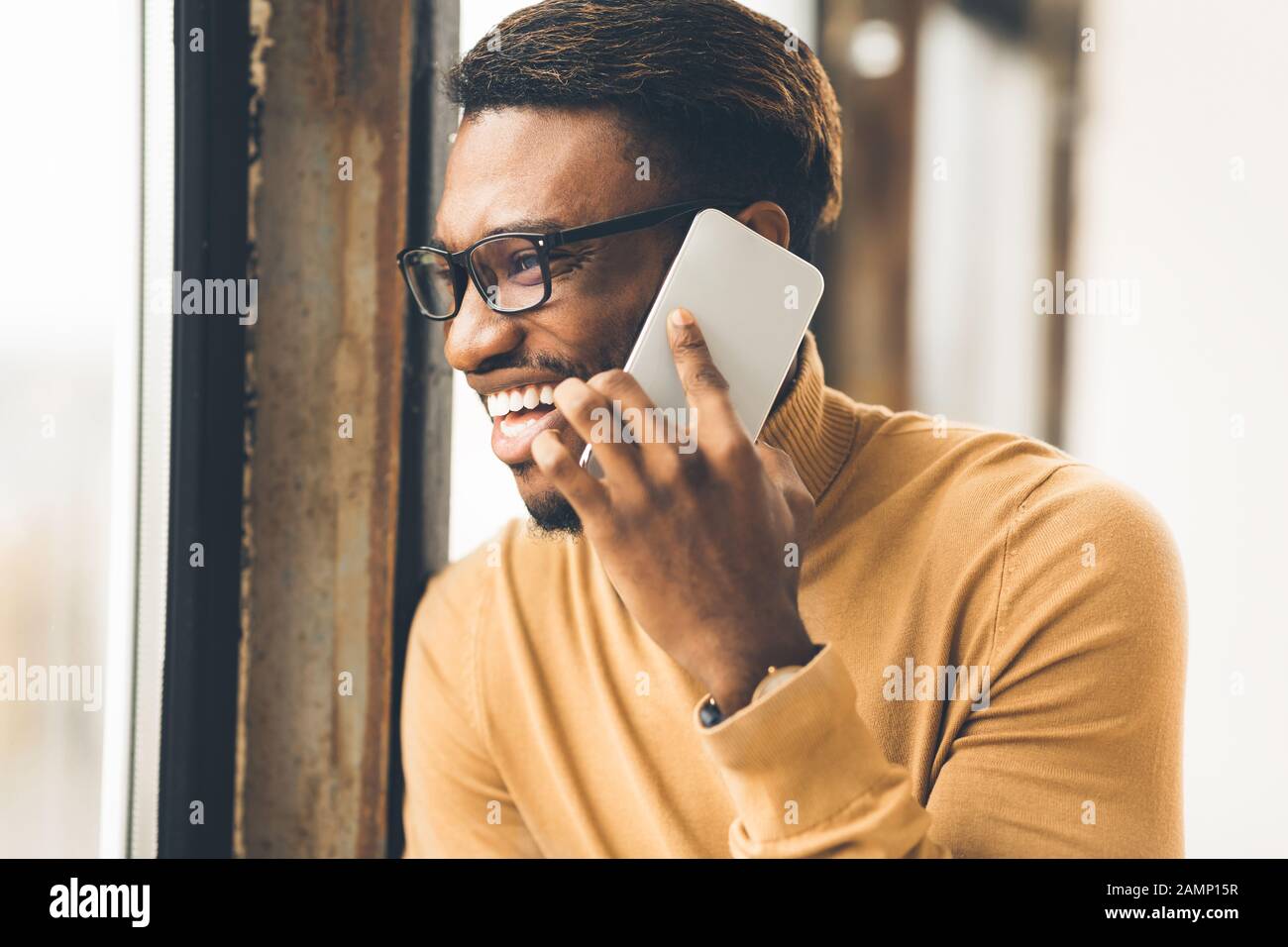 Cheerful guy talking on cell hi-res stock photography and images - Alamy