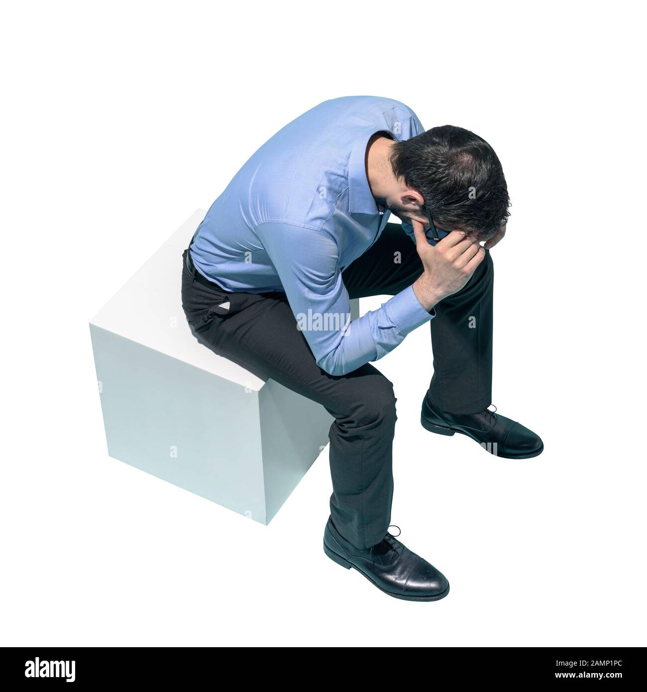 Stressed man sitting with head in hands and feeling depressed, white ...