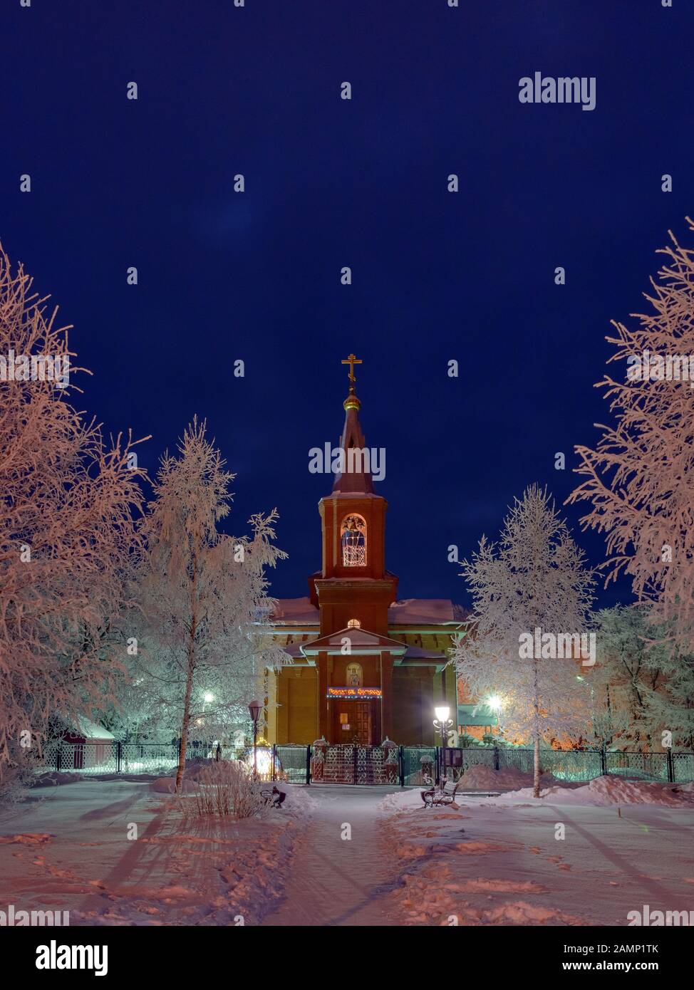 The building of the Orthodox Church at night surrounded by trees in the ...
