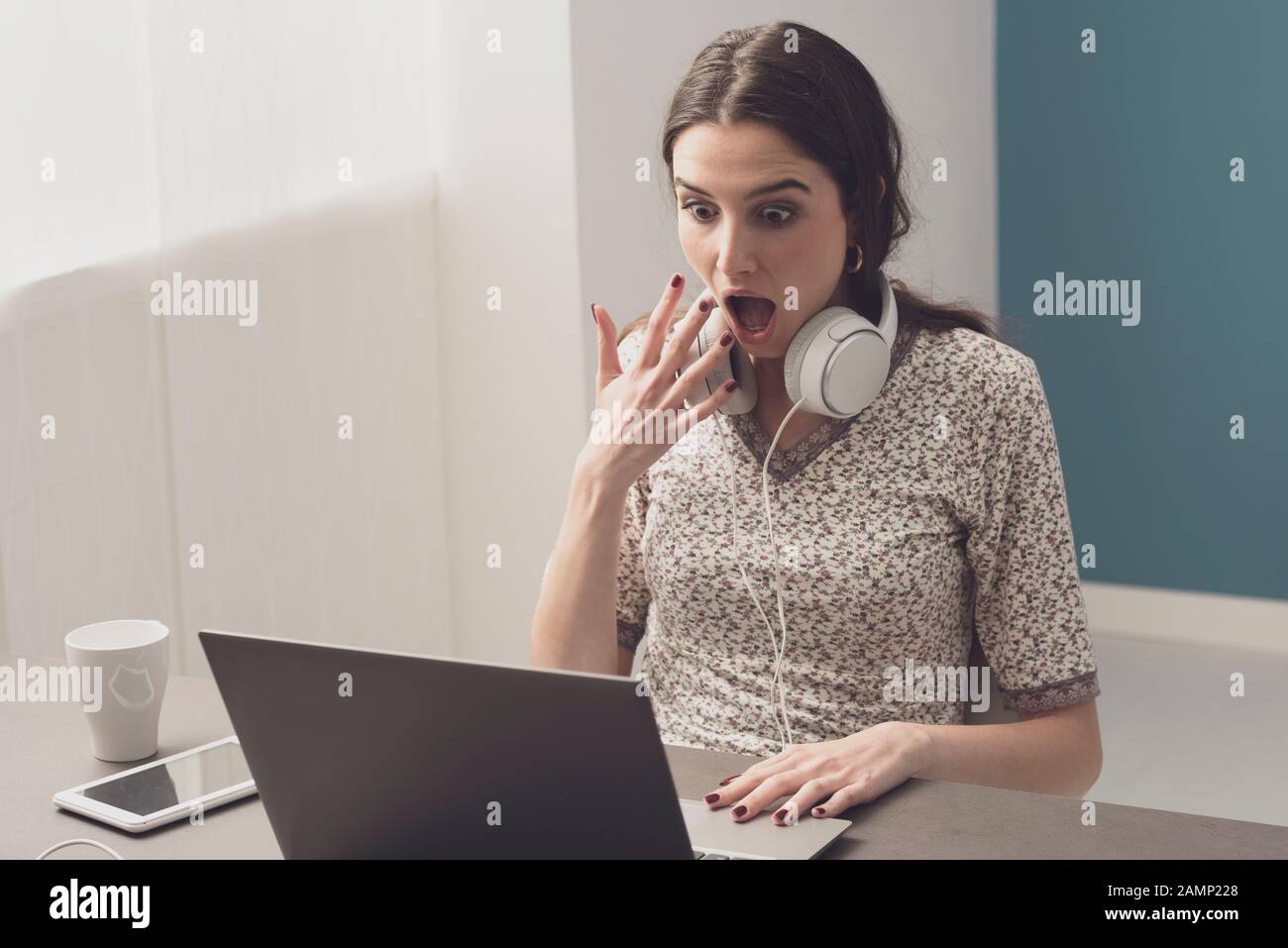 Young woman working with her laptop, suddenly she gets a system failure ...