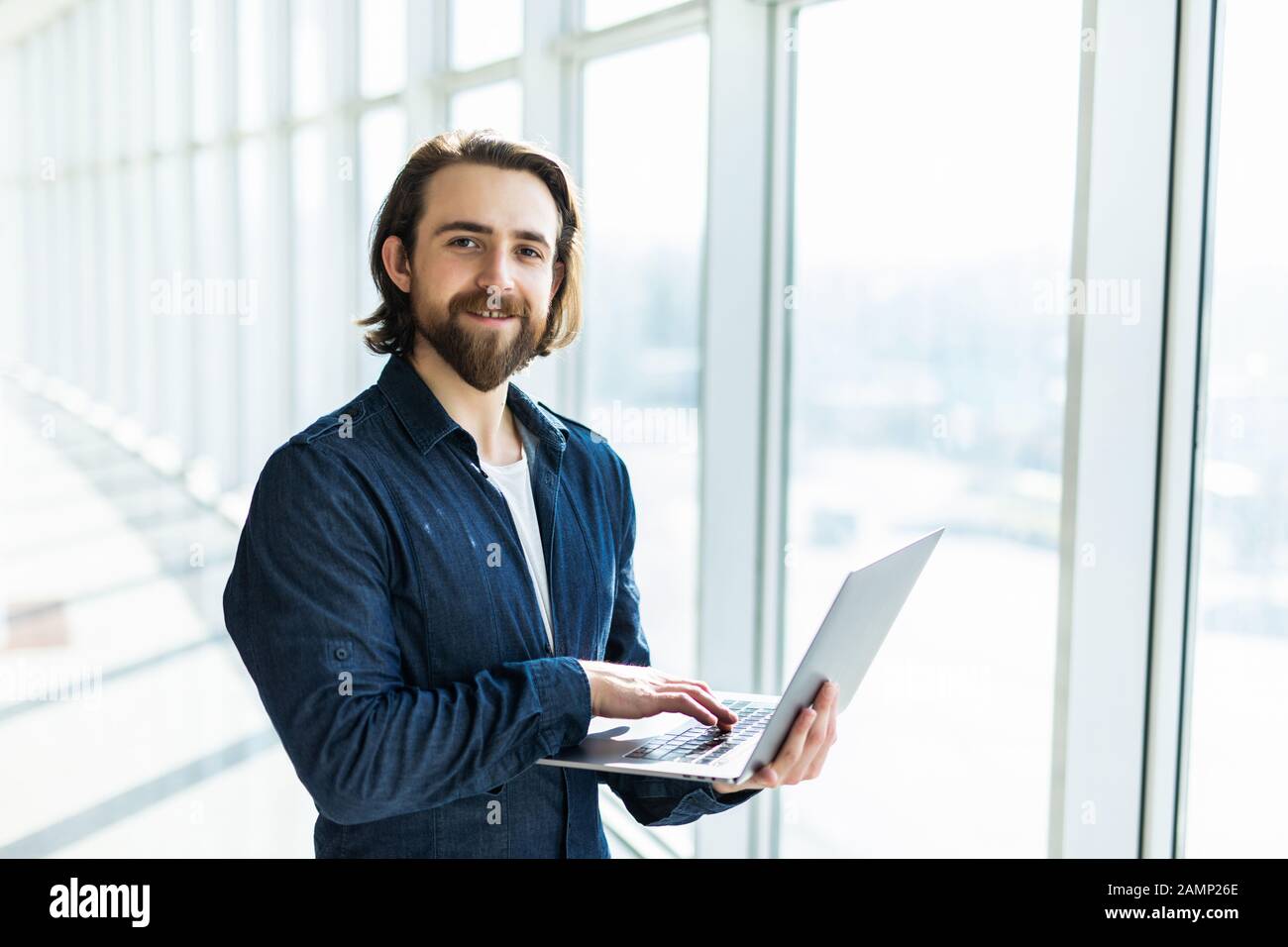 Business man using laptop in black suit with panoramic city view ...