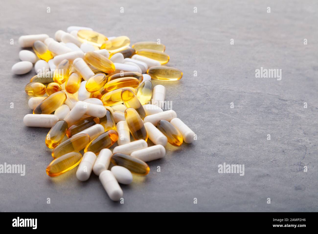 Tablets, pills, capsules, drugs pouring out of white bottle on white ...