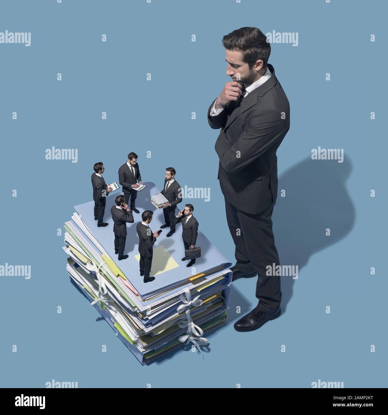 Confident corporate businessman supervising a business team at work ...
