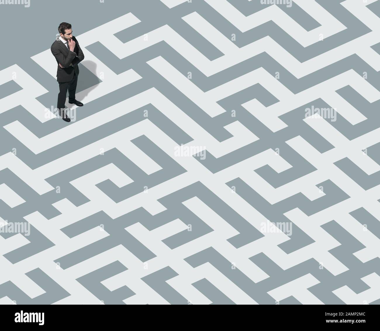 Businessman standing on a maze and searching for a way out, solution ...