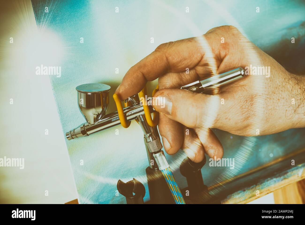 Professional airbrush in artist hand Stock Photo - Alamy