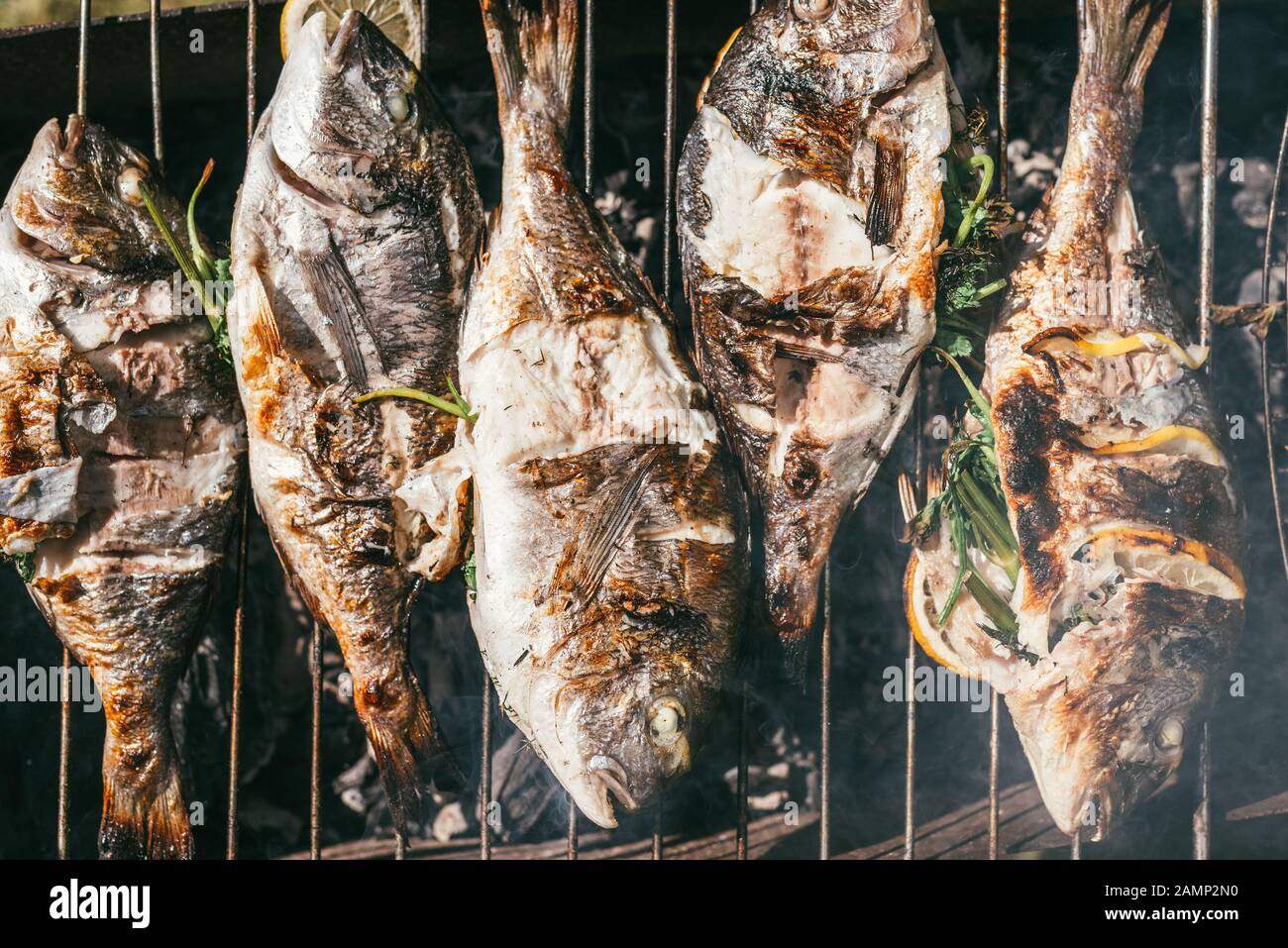 Delicious and fresh grilled fish with lemon on the Barbeque grill at ...