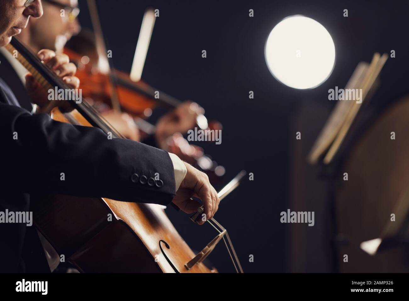 Symphonic orchestra performing on stage and playing a classical music ...