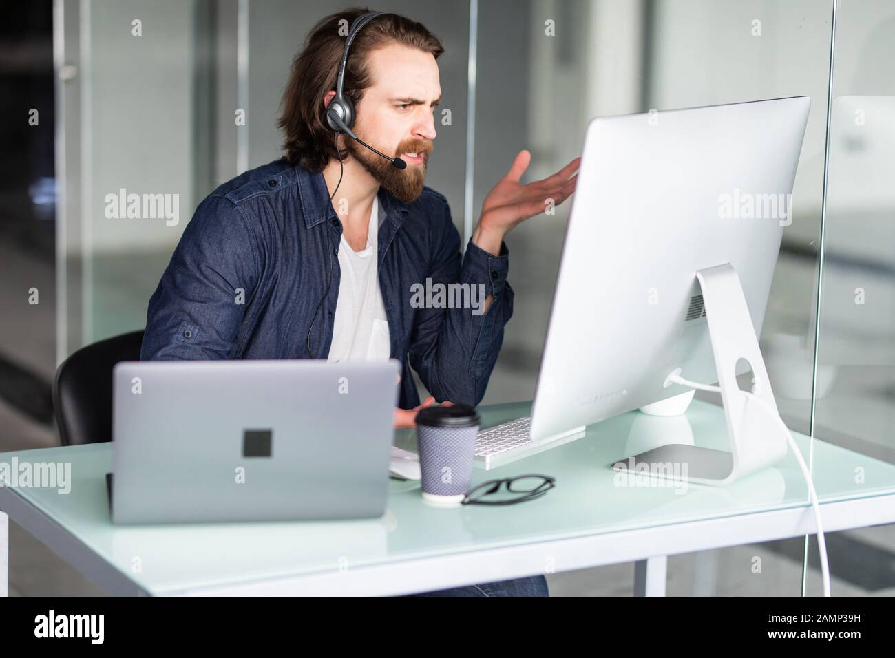 Call center operator working at his desk Stock Photo - Alamy