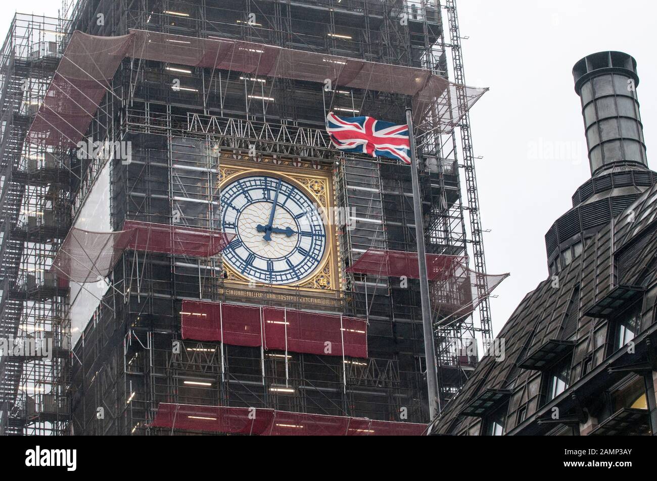 London, UK. 14th Jan, 2020. One face of Big Ben not covered by ...