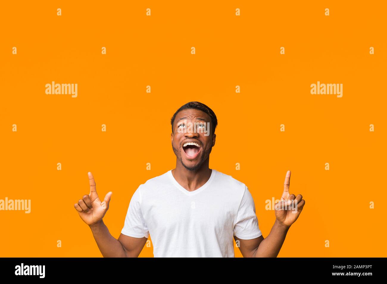 Excited Guy Pointing Fingers Up Standing On Orange Background, Studio ...