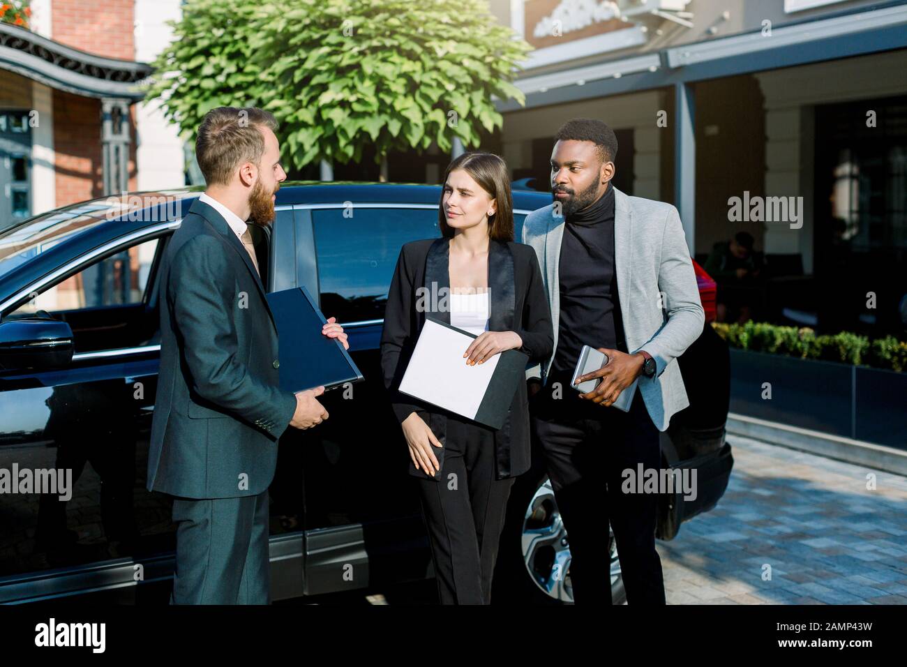 Business people meeting outdoors. Picture of young attractive ...