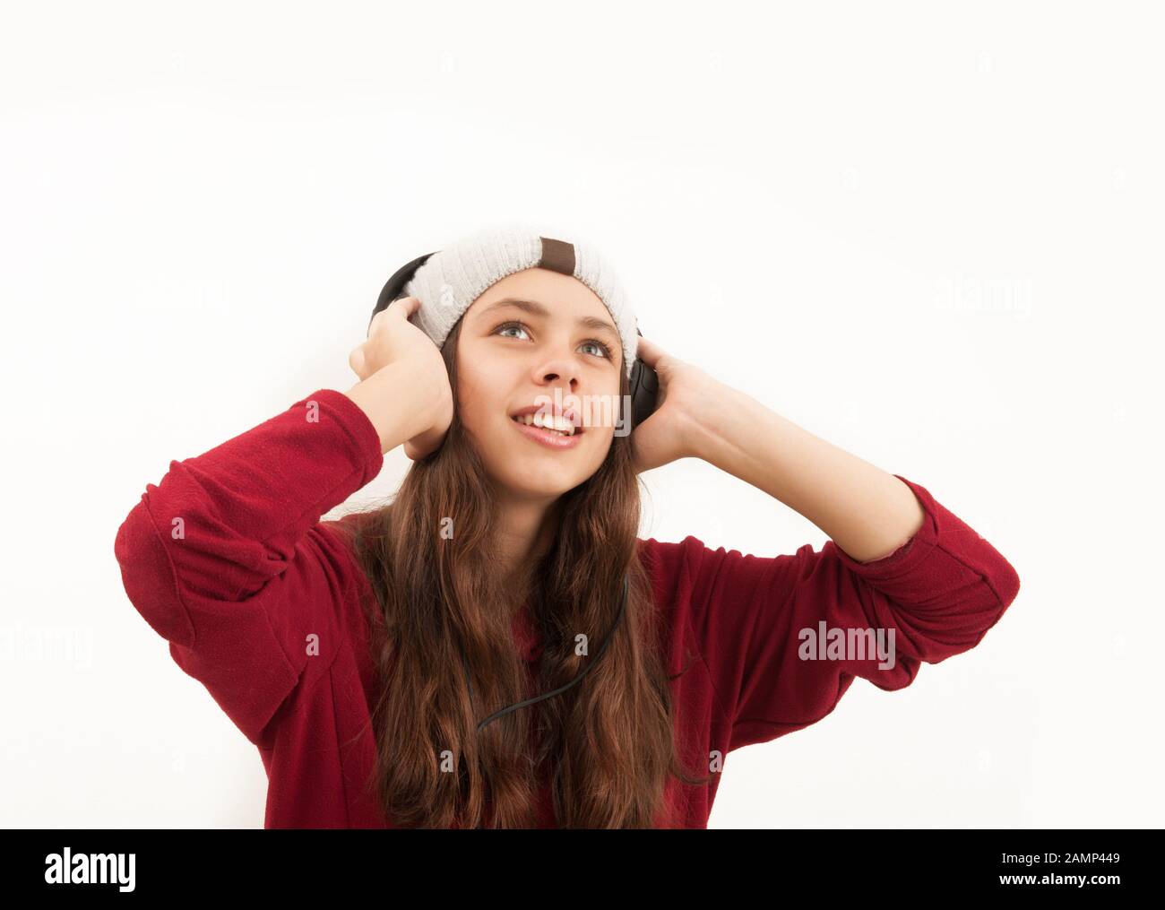Girl in headphones on a white background listens to music Stock Photo ...