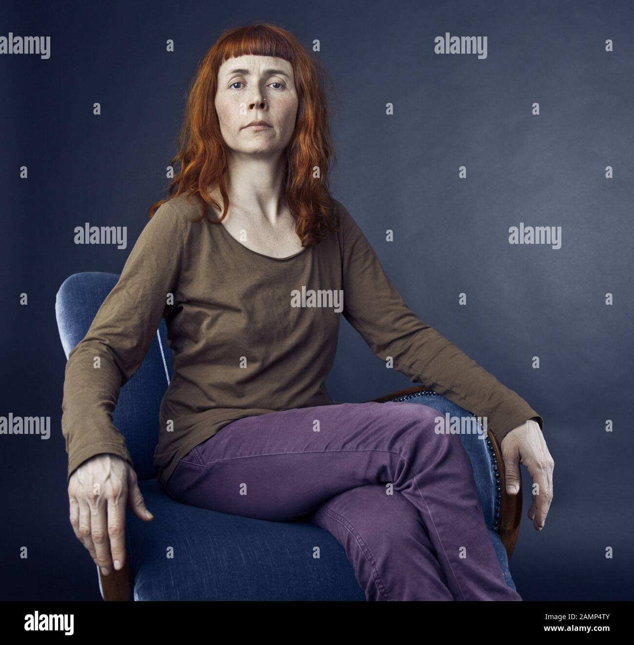 Woman in chair looking superior Stock Photo - Alamy