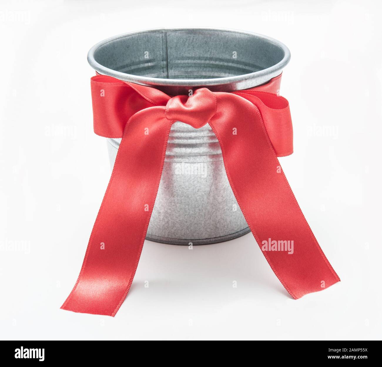 Iron bucket with a red bow on a white background Stock Photo - Alamy
