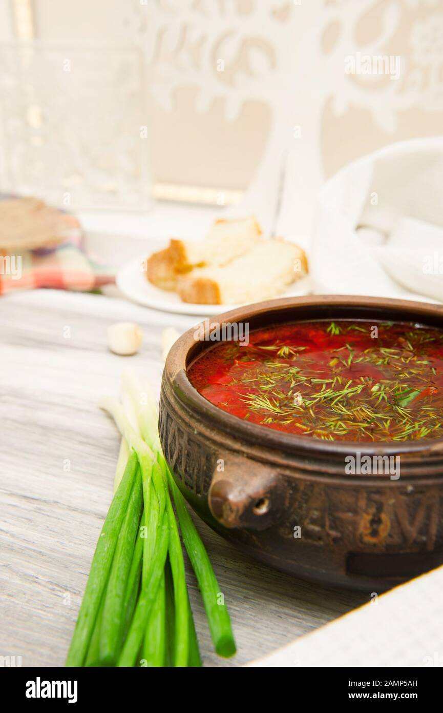 Ukrainian borsch with green onions, bread and garlic.. National food ...