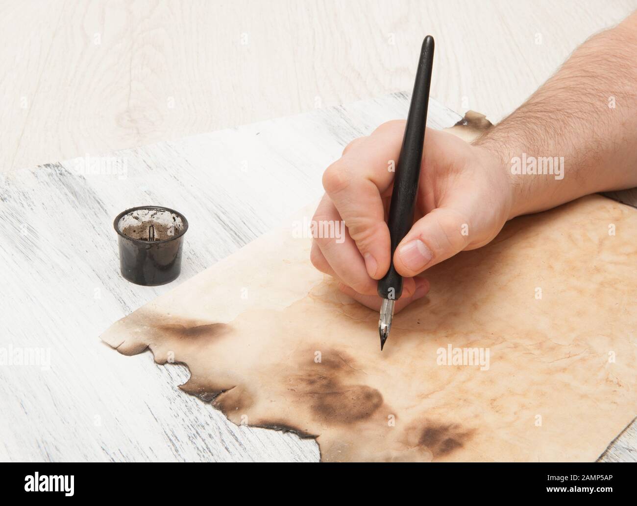 Male hand with pen writes on old paper Stock Photo - Alamy