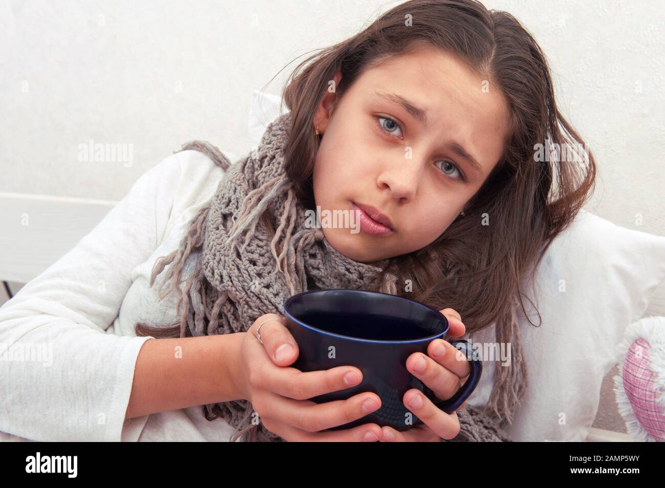 The girl in bed is sick, drinking tea Stock Photo - Alamy