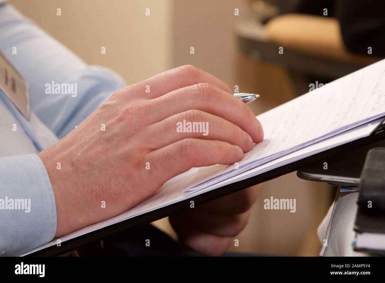 Taking notes at a business meeting or conference Stock Photo - Alamy