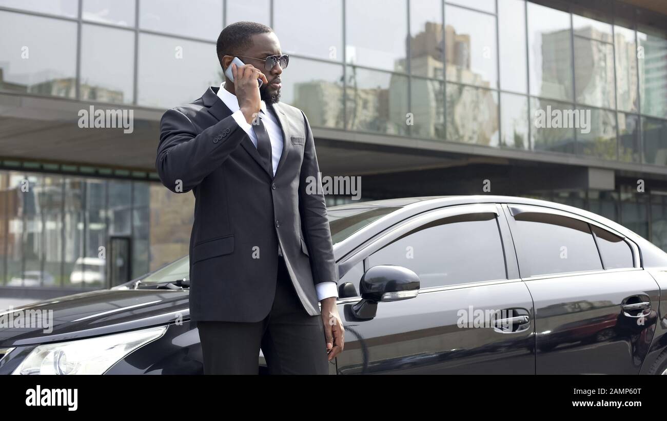 Detective of secret service receiving instructions by phone, security ...