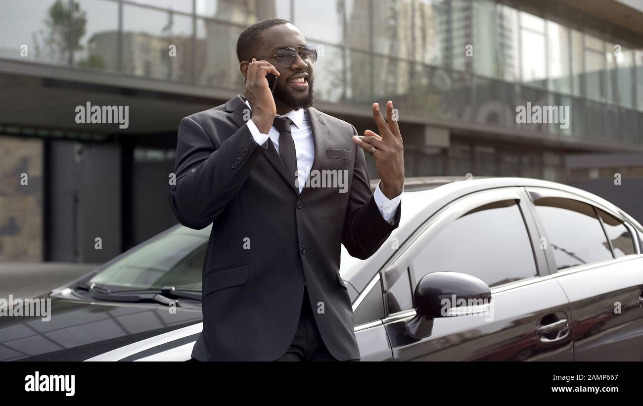 Employee talking on phone to boss, telling about successful business ...