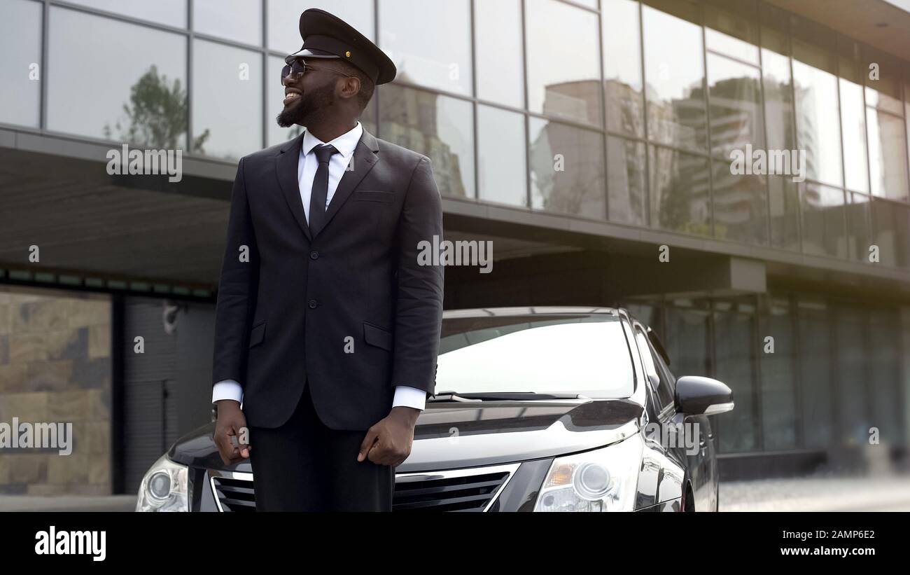 Airport taxi driver waiting for client arrival, transfer service at ...